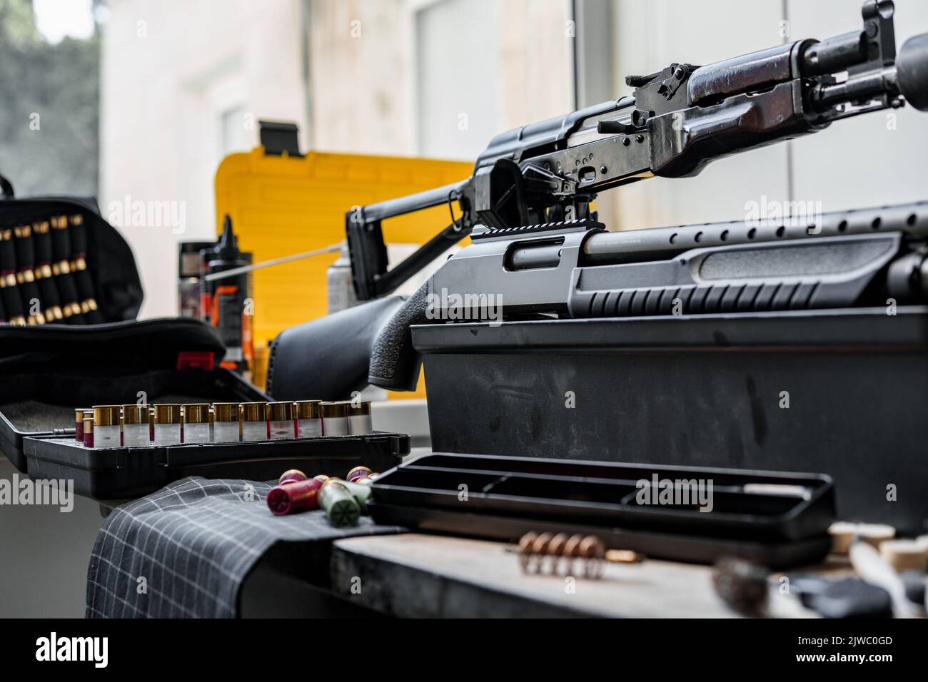 Shotgun rifle with cartridges on table in a weapon workshop Stock Photo ...