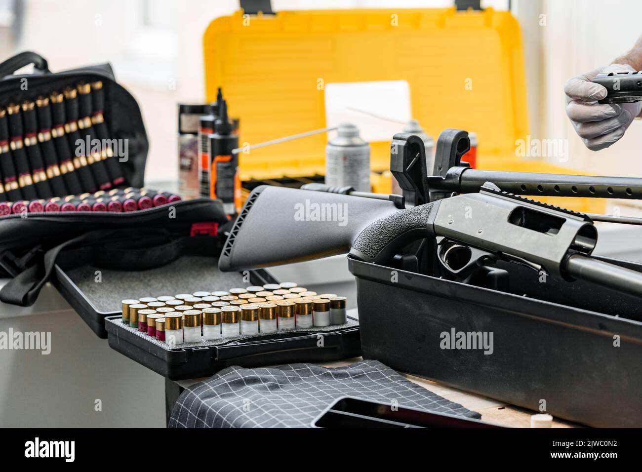 Shotgun rifle with cartridges on table in a weapon workshop Stock Photo ...