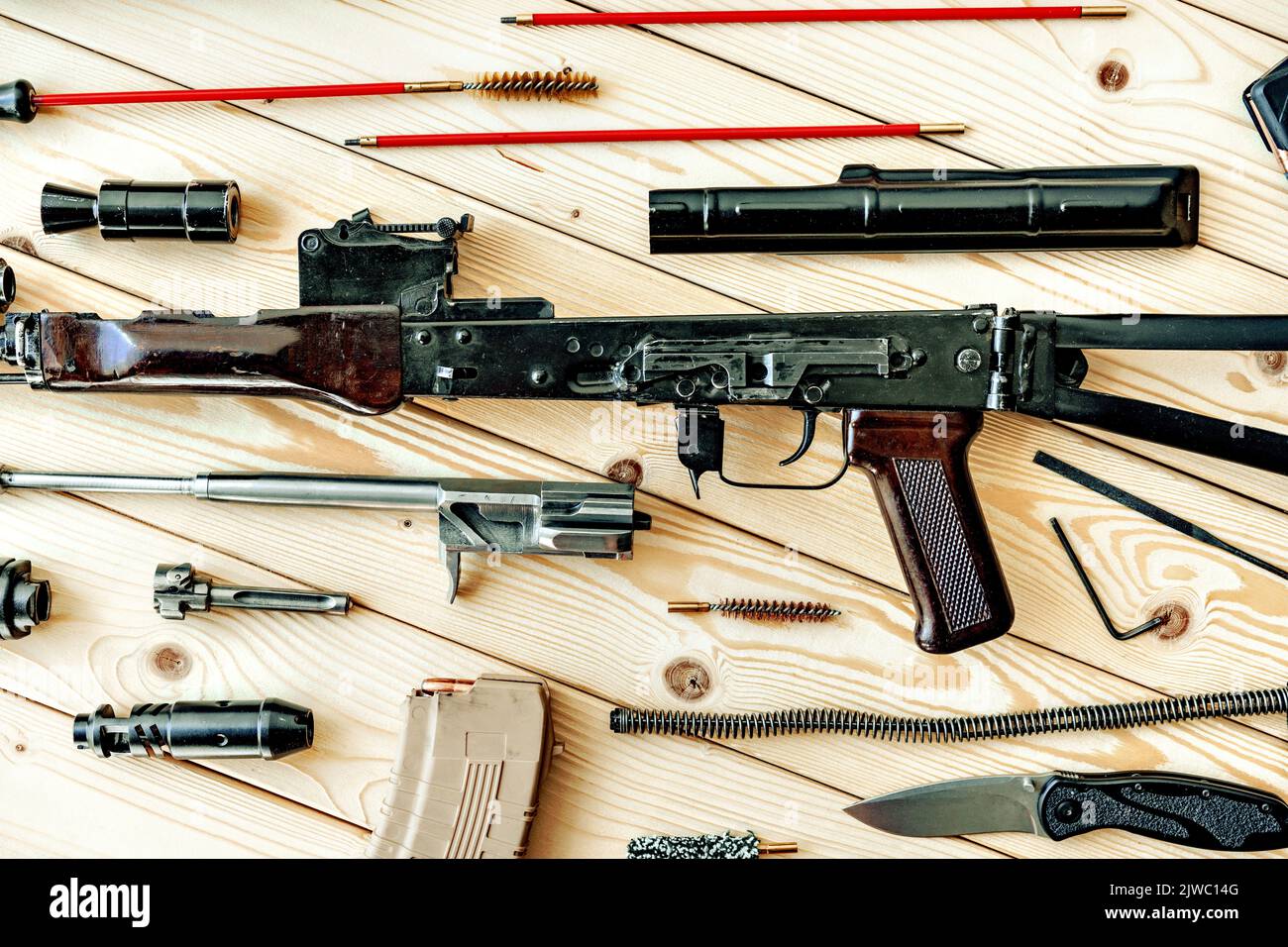 Disassembled rifle with cleaning tools on table of weapons workshop ...