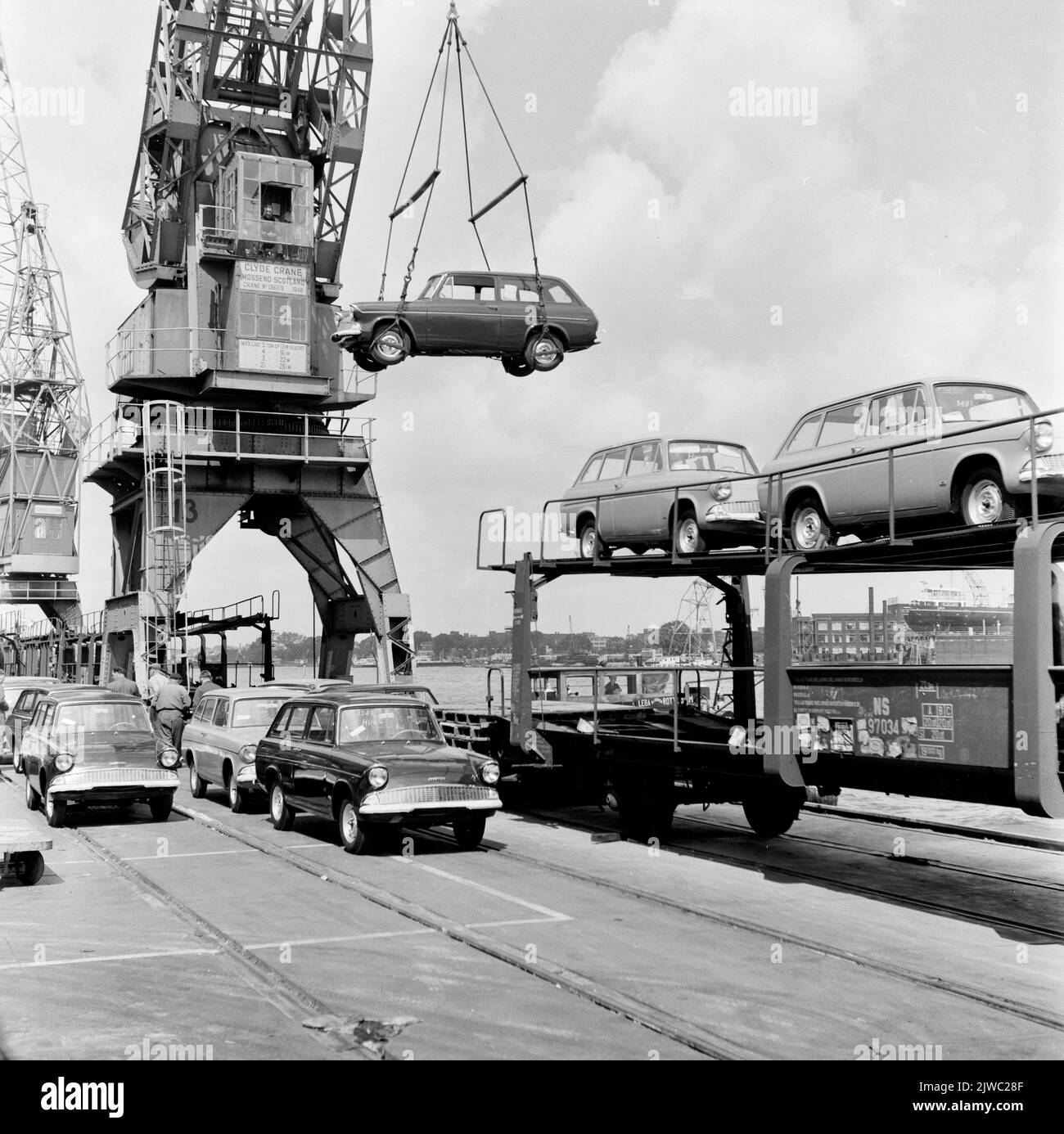 Image of overloading passenger cars (Ford Anglias) from a ship to train ...