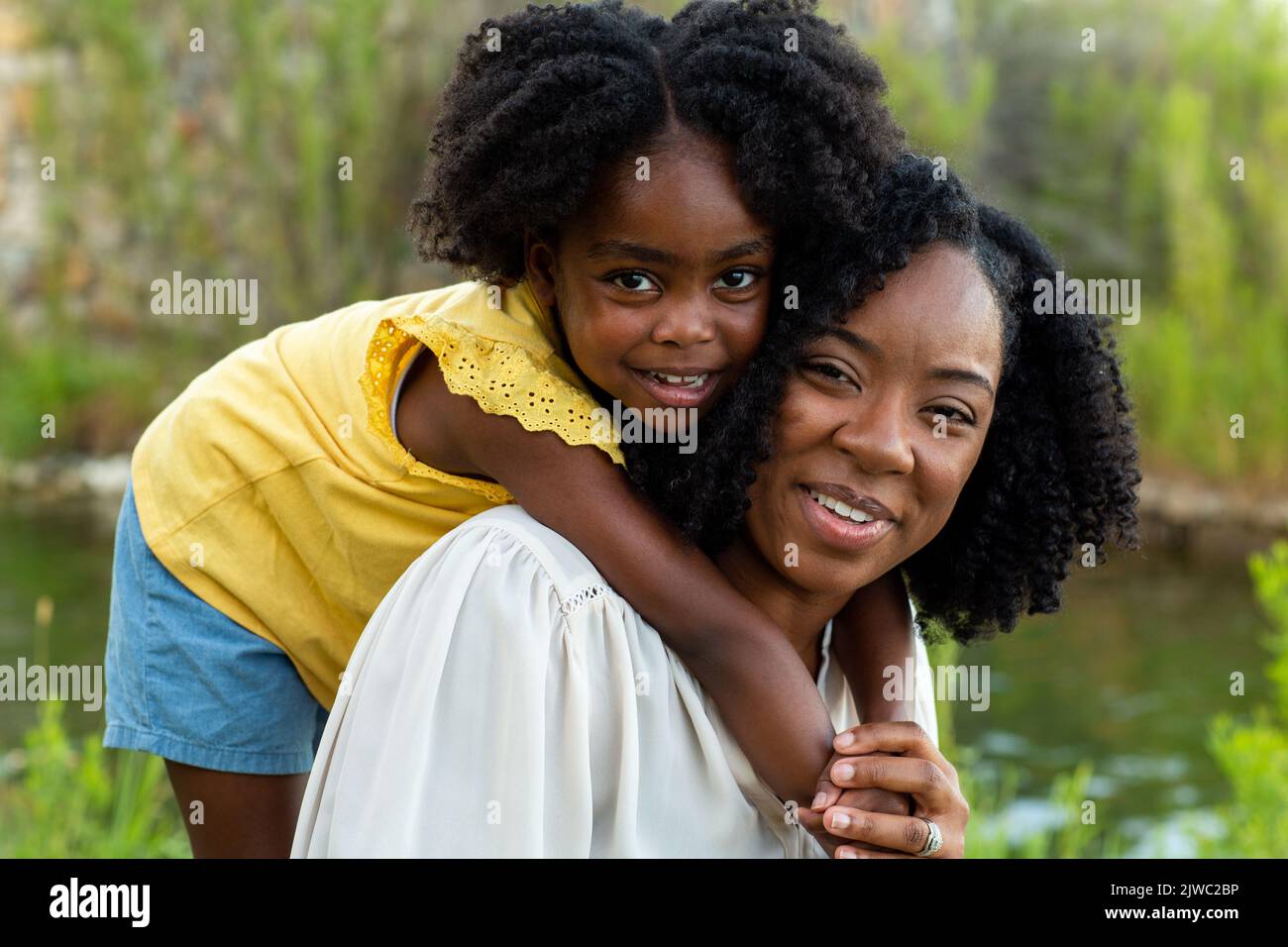 Happy mother and her beautiful daughter smiling Stock Photo - Alamy