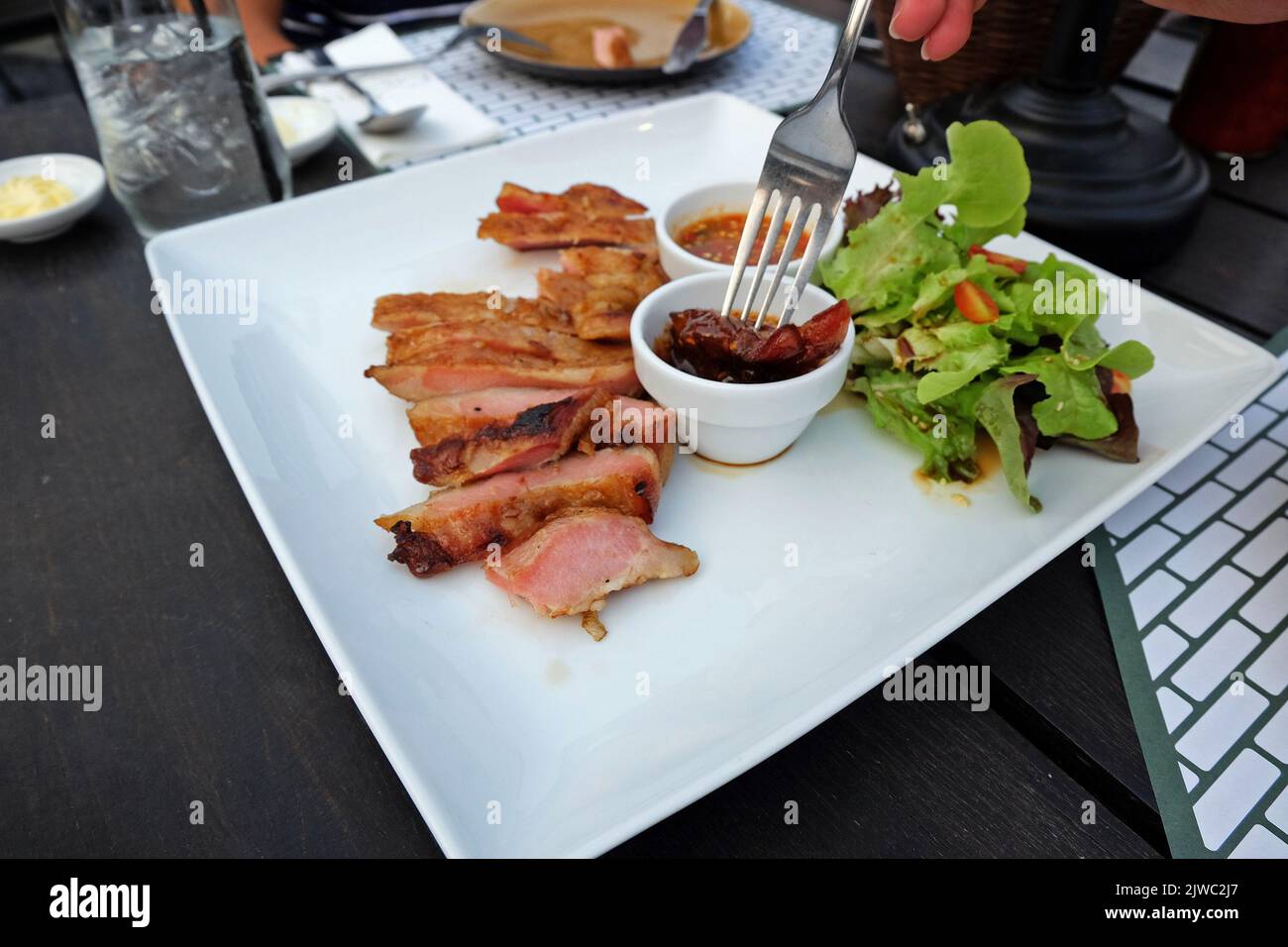 Close up dish of Sliced honey barbecue pork Stock Photo - Alamy