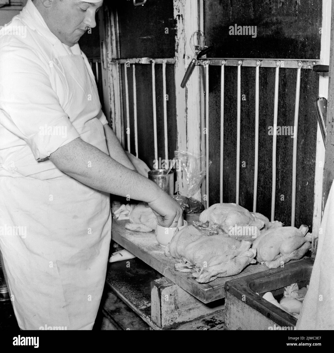 Image of a cook during the preparation of chickens in the kitchen of ...