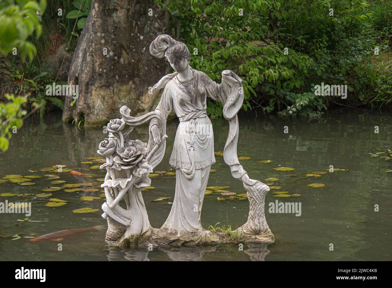 The view of a marble statue of a woman wearing kimono placed in the ...