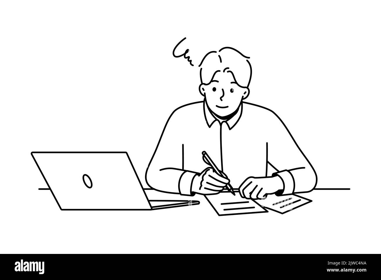 Young man sit at desk working on laptop making notes on paper. Guy ...