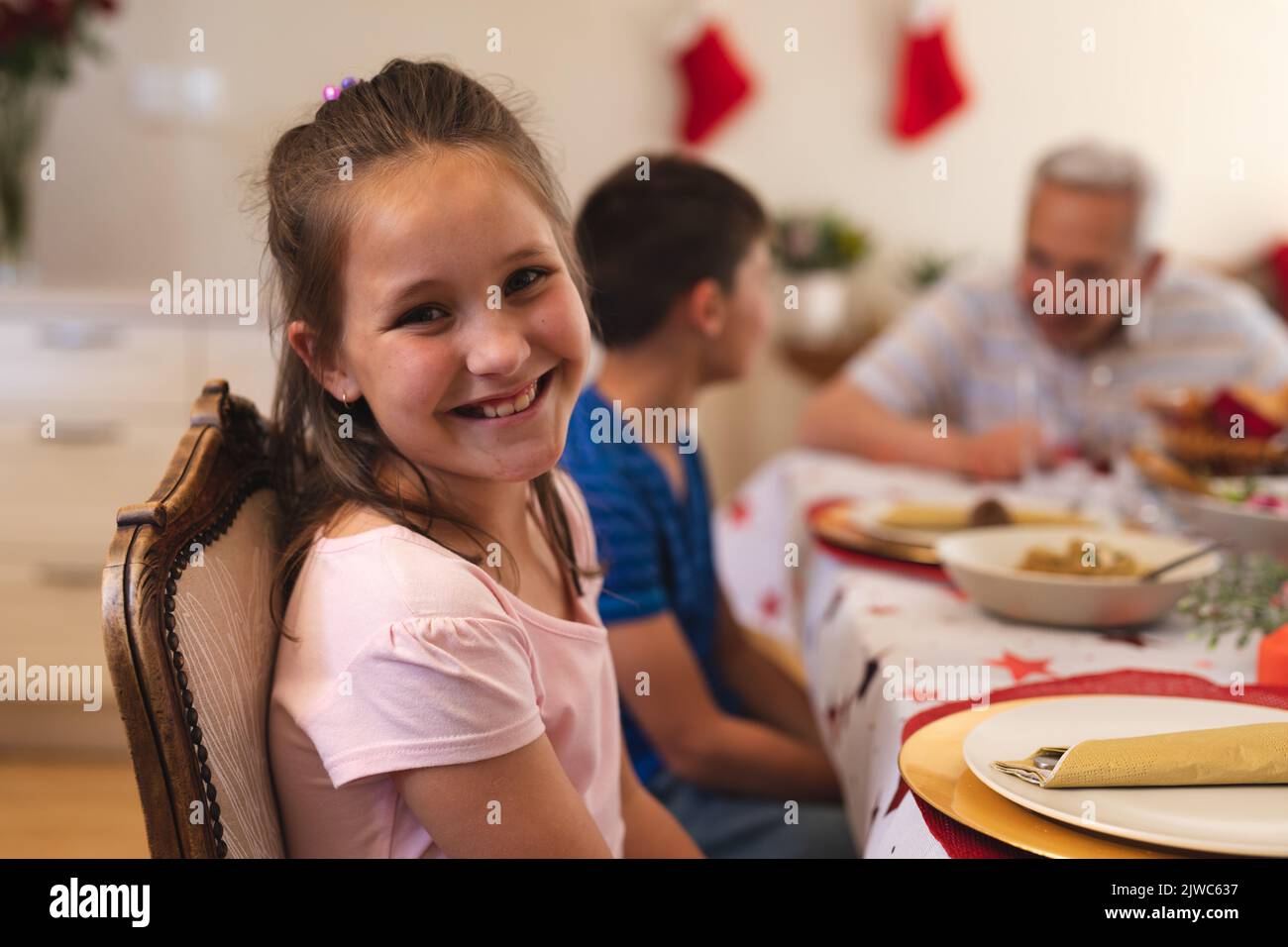 Portrait of caucasian girl sitting at table for dinner Stock Photo - Alamy