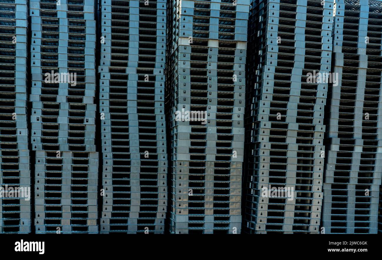 Pile of plastic shipping pallet. Industrial plastic pallet stacked at ...