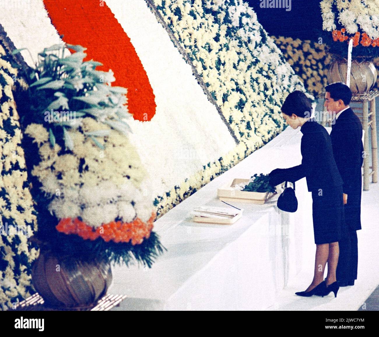 Japanese Crown Prince Akihito and Crown Princess Michiko offer flowers ...