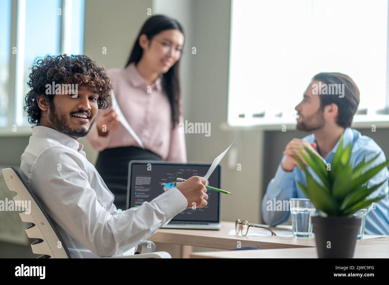 Group of young professionals working together in the office Stock Photo ...