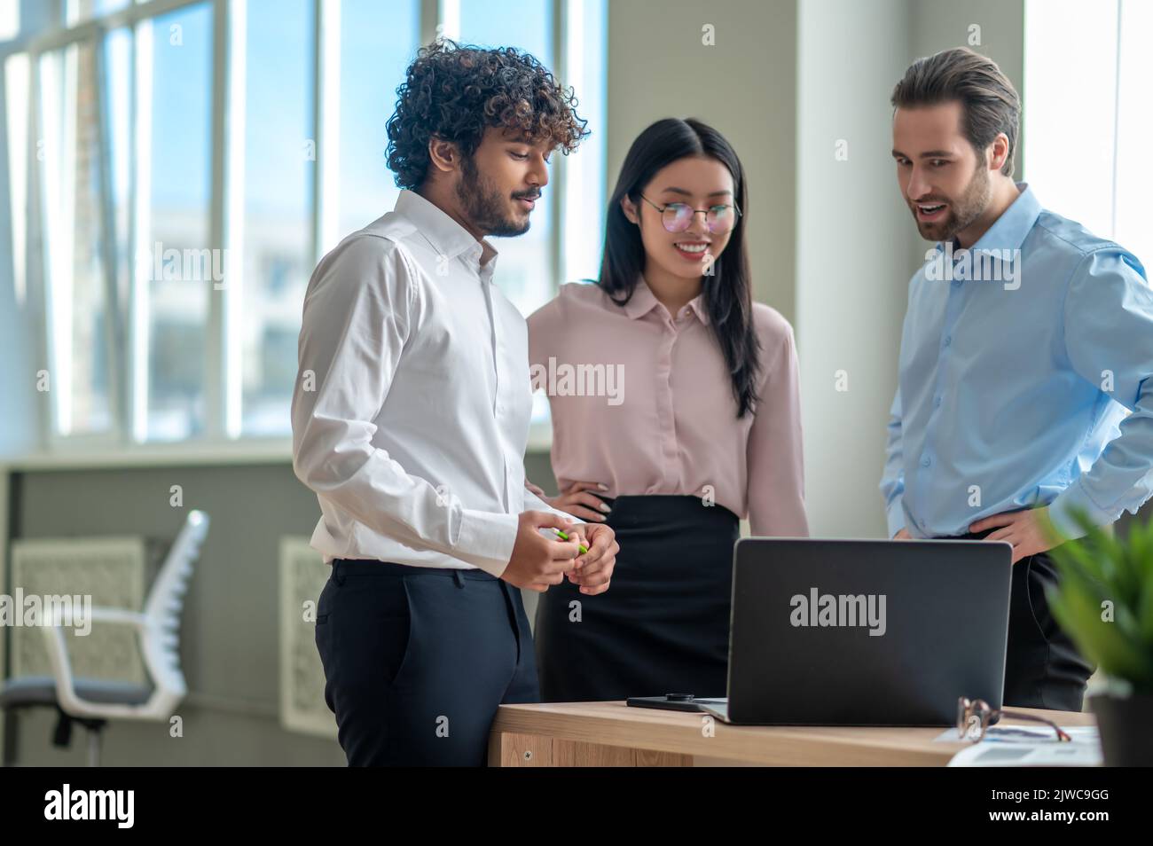 Group of young professionals working together in the office Stock Photo ...