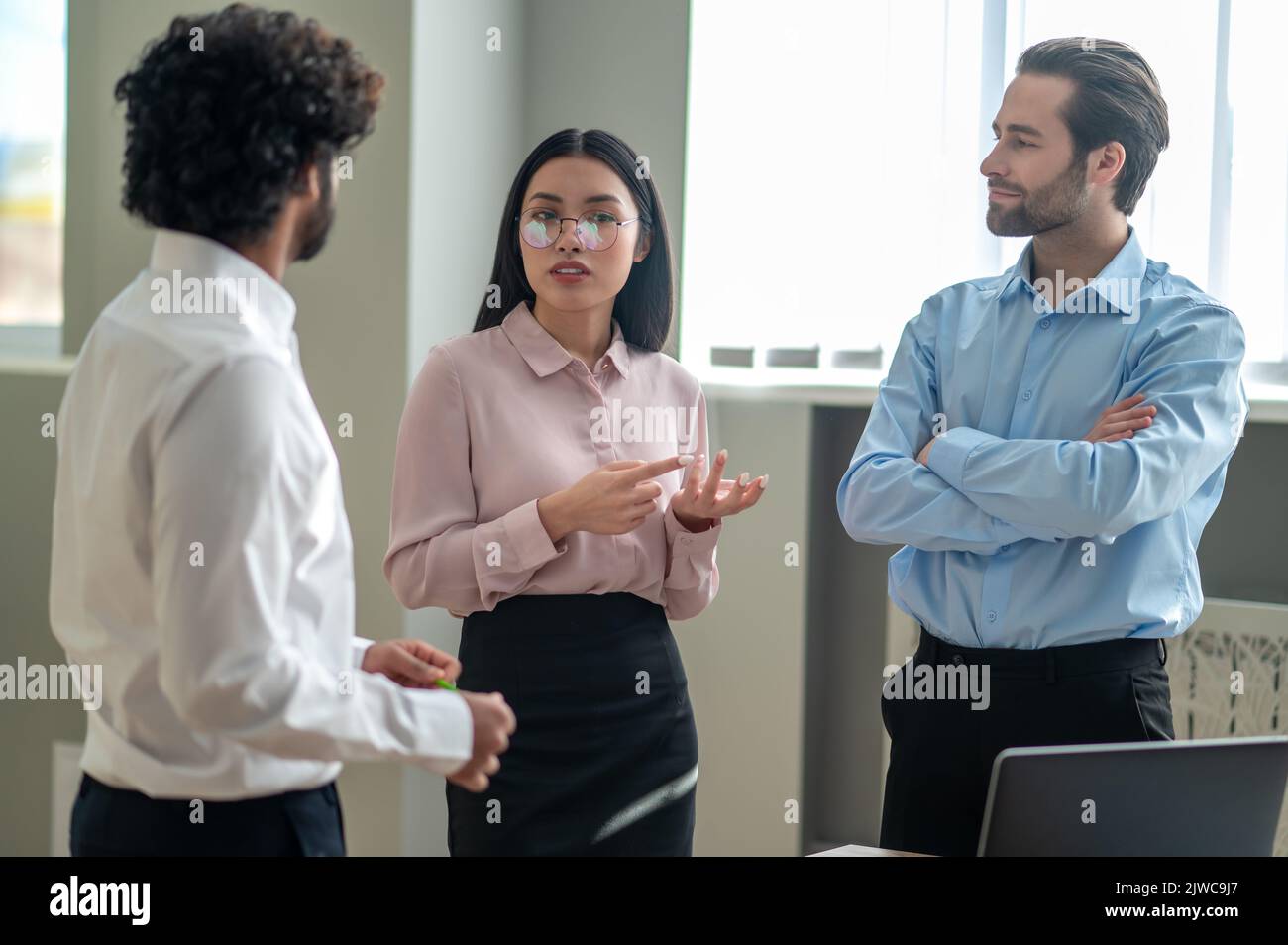 Business colleagues talking in the officce and looking involved Stock ...