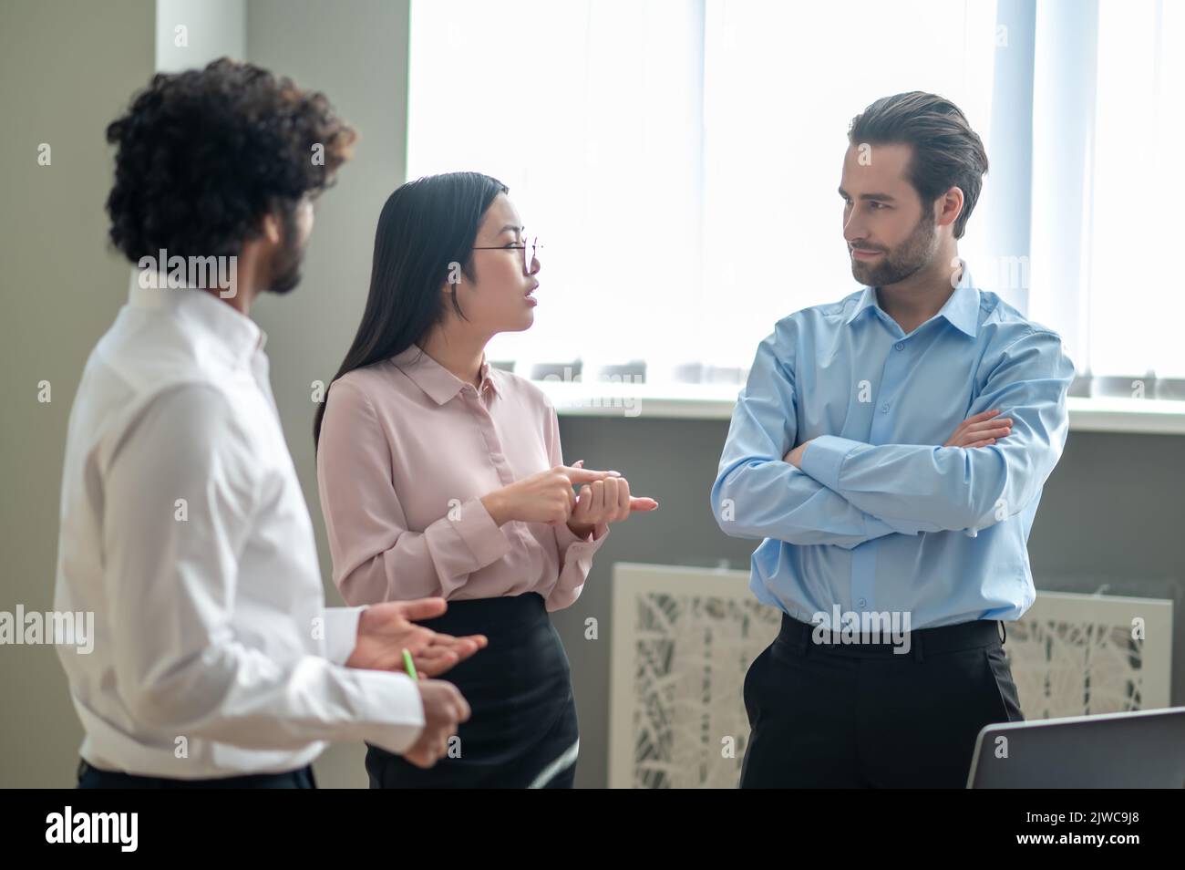 Business colleagues talking in the officce and looking involved Stock ...