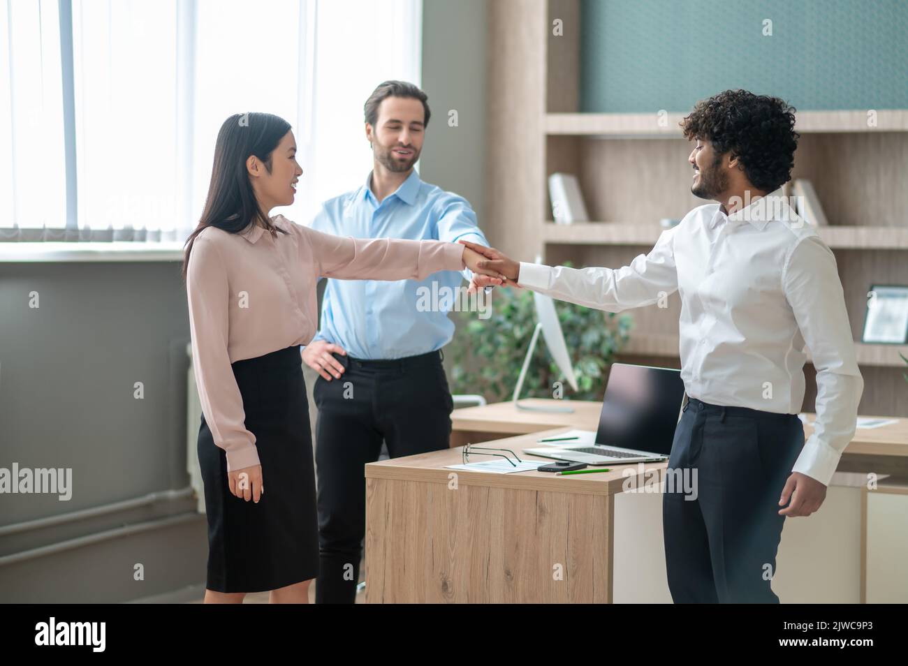 Young business people looking excited and happy Stock Photo - Alamy