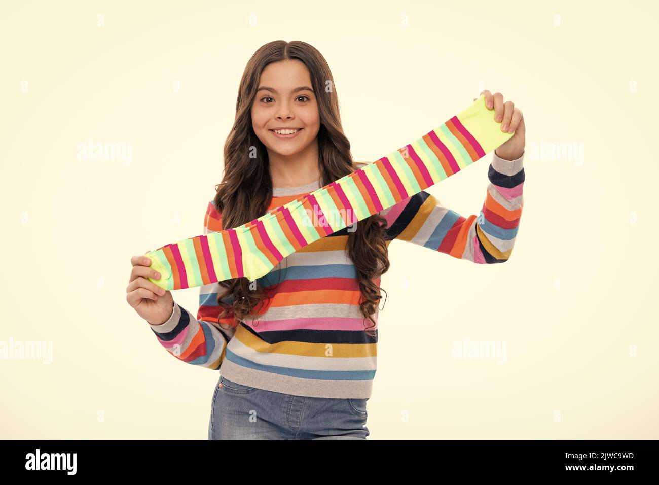 Teen hold strip sock on white background. Child holding a pair of ...