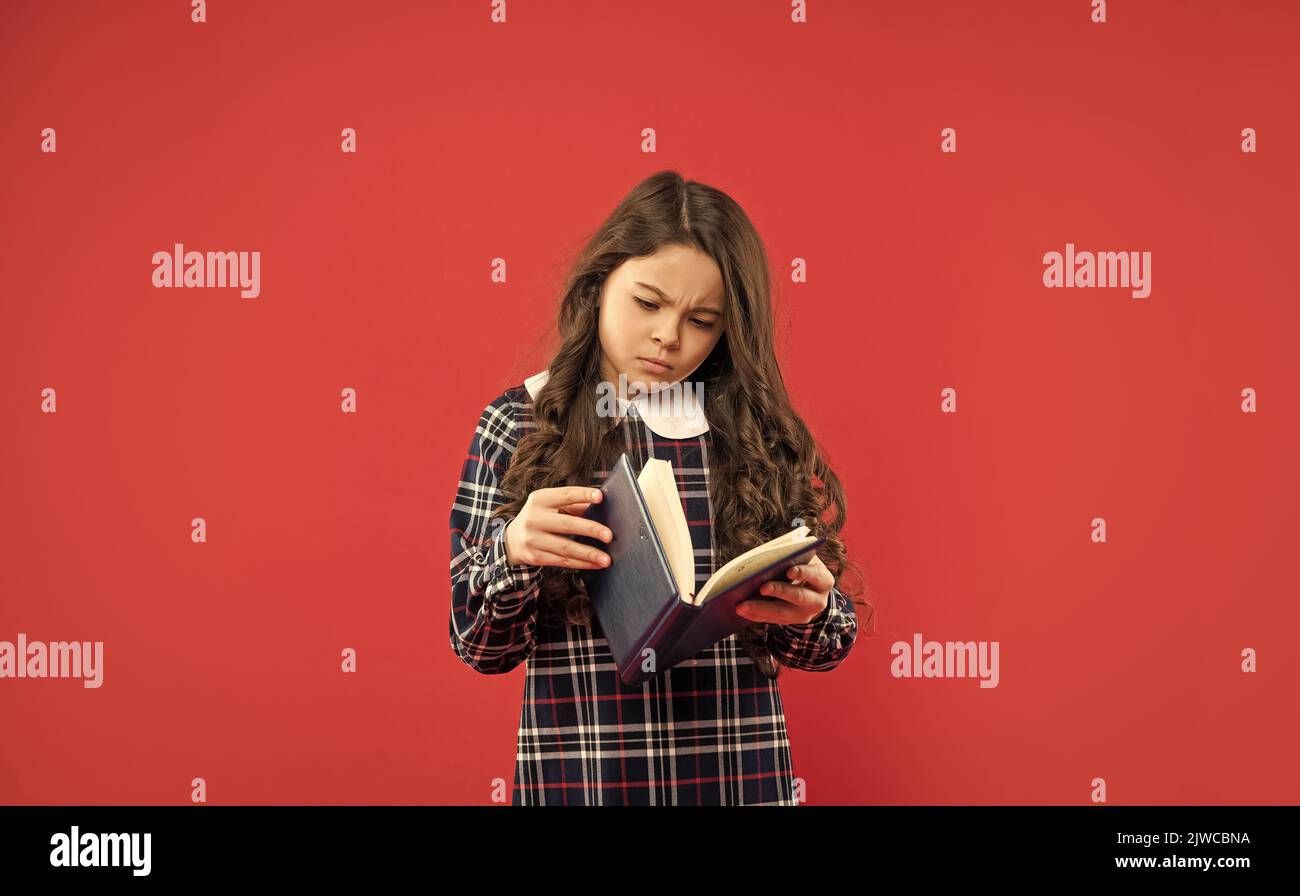 curious kid hold notebook on red background, study Stock Photo - Alamy