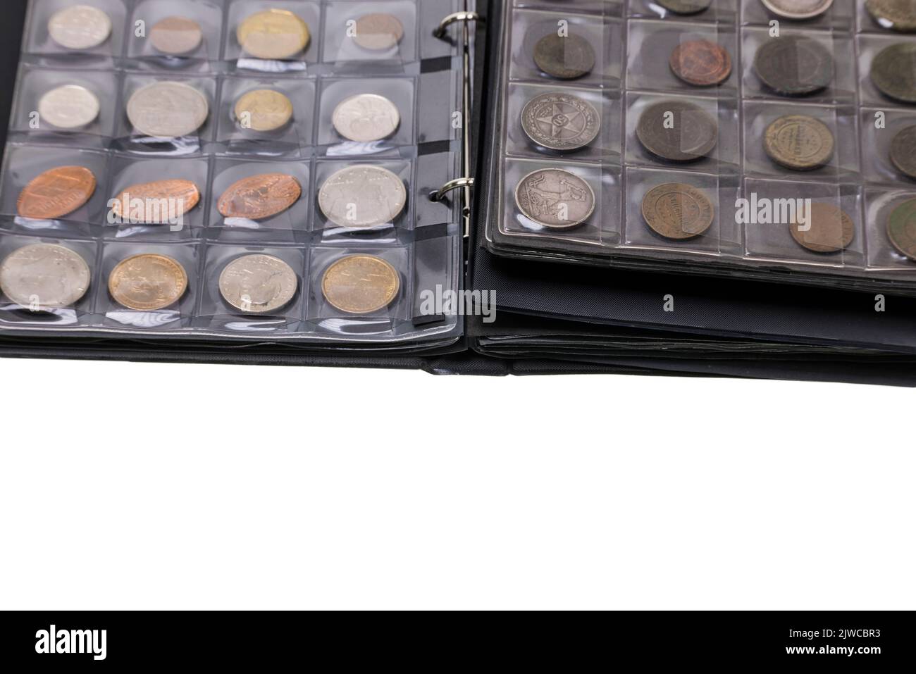 View of album with collectible old coins from different countries ...