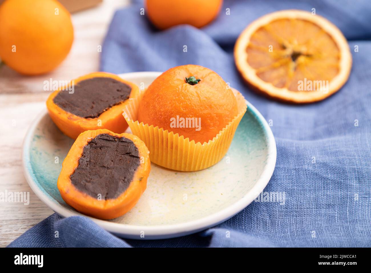 Truffle chocolate tangerine candies on a white wooden background and ...