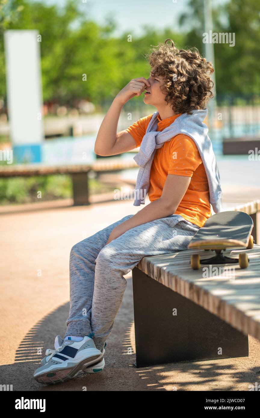 Boy feeling disgusted by bad smell in the air Stock Photo - Alamy