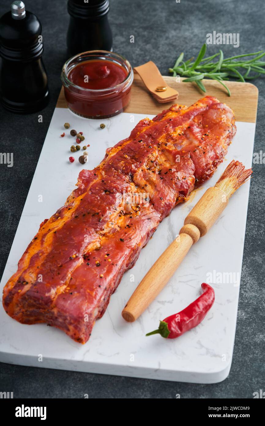 Pork ribs. Raw meat. Raw pork ribs in marinade with spices, rosemary ...