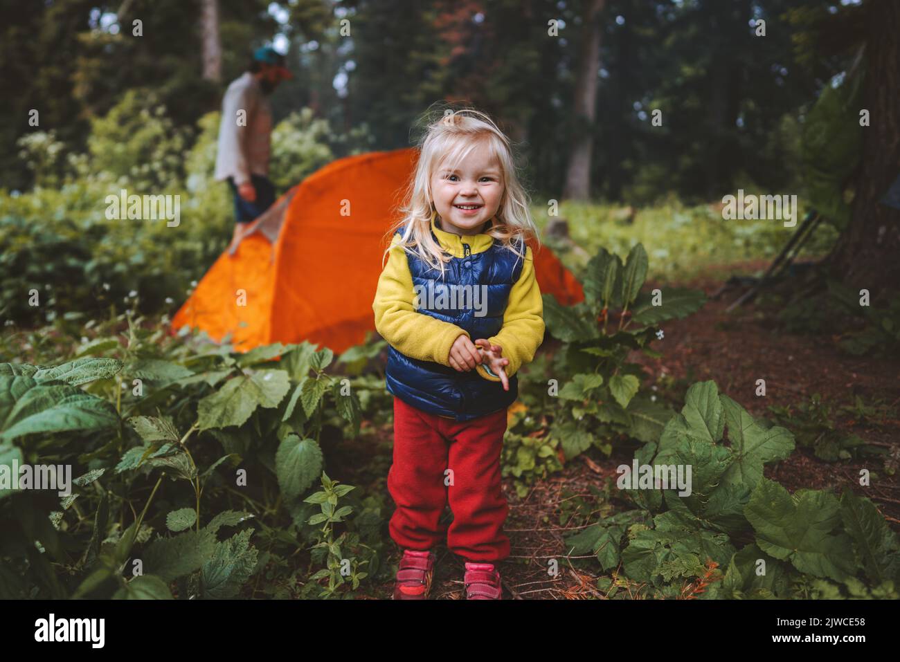 Child girl in forest traveling family camping tent gear adventure ...
