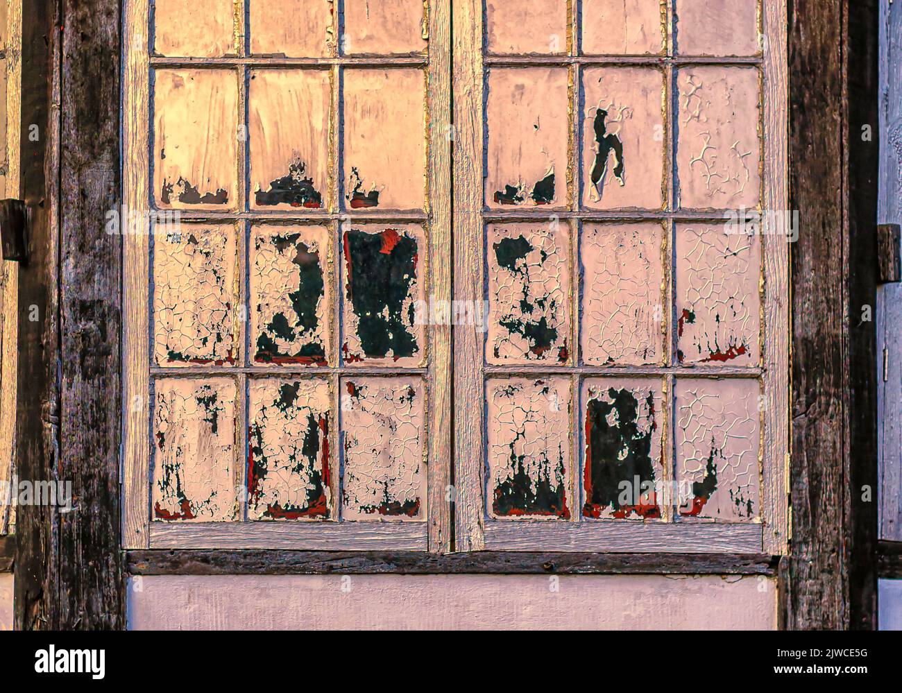 Paint peeling off the painted glass of a weathered wooden window Stock ...