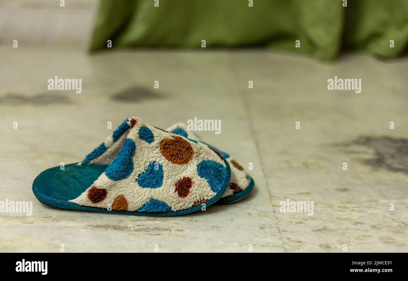 A pair of bathroom slippers / bath slippers / toilet slippers lying on ...