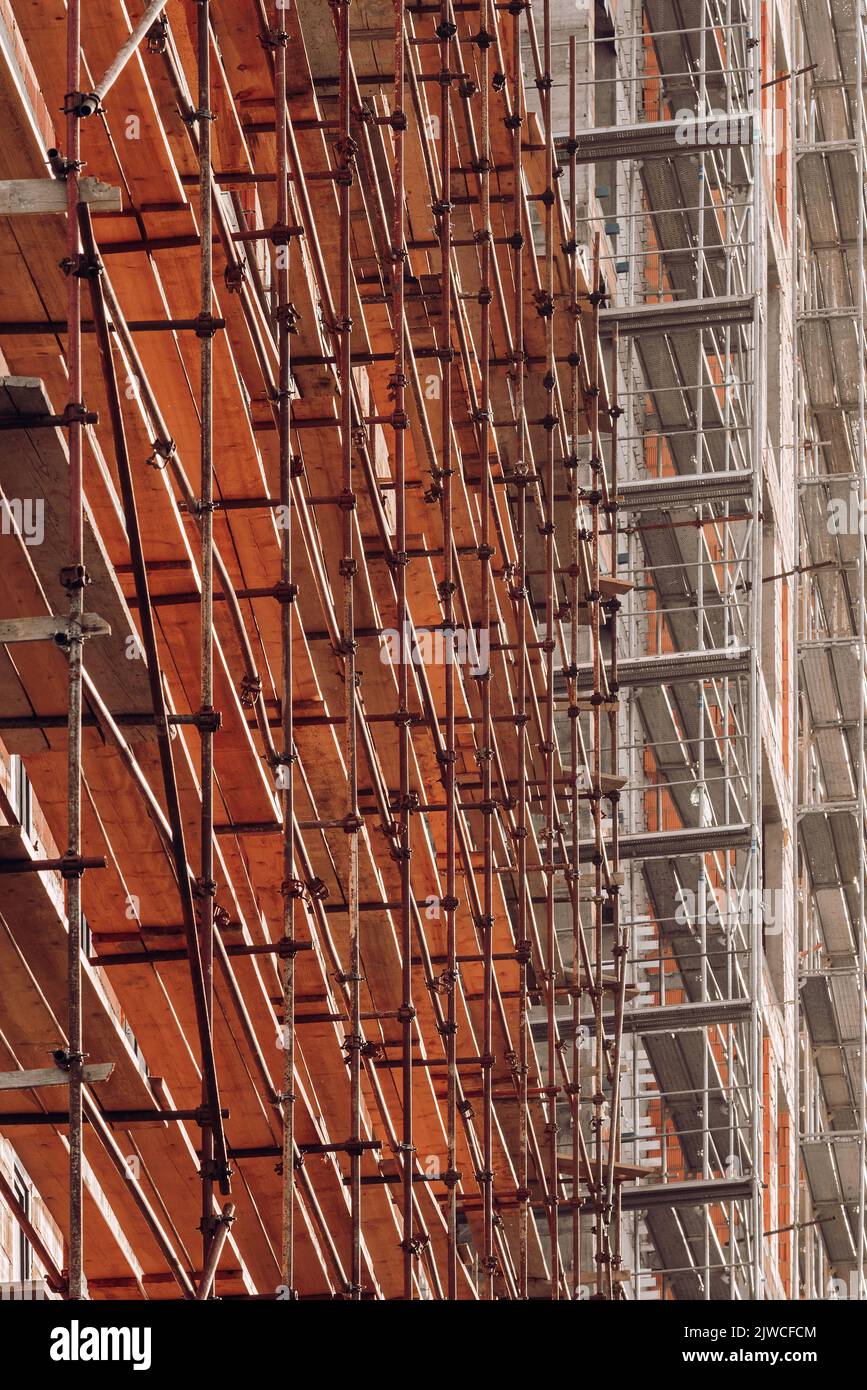 Scaffolding surrounding a high-rise building, low angle view with ...