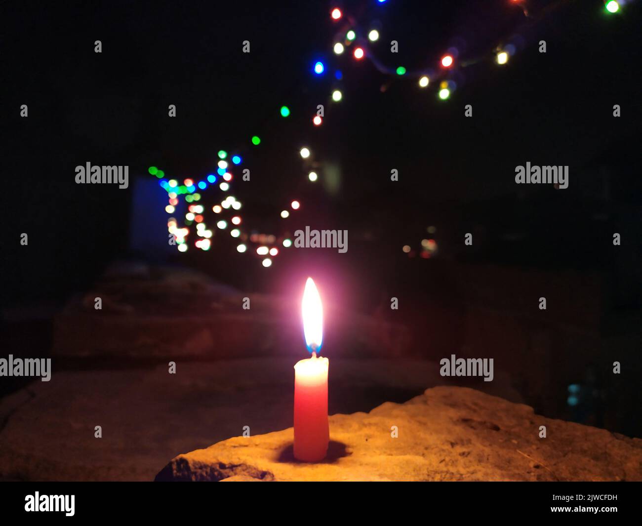 a candal flame is lightning in very dark night Stock Photo - Alamy