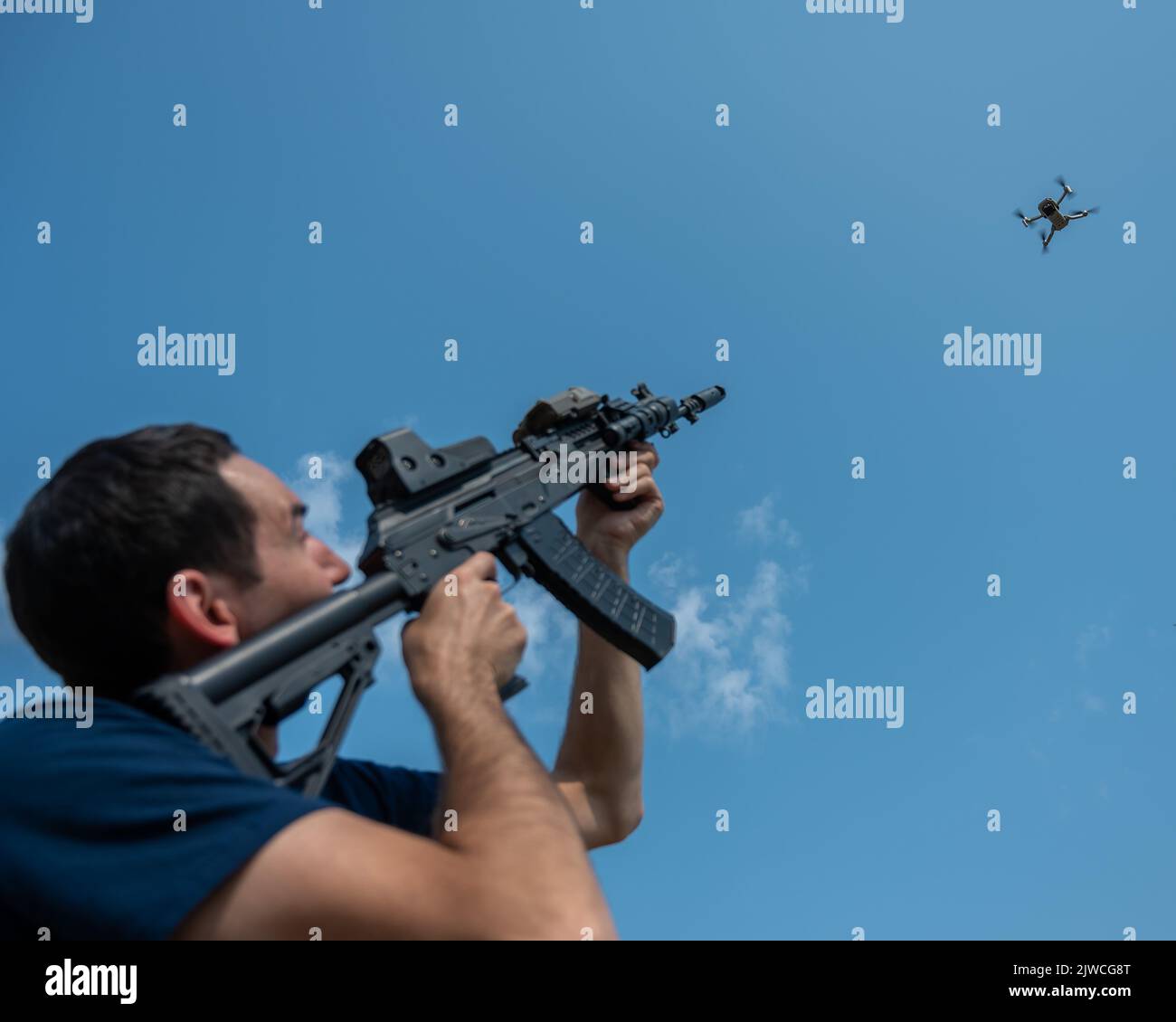 Caucasian man shoots a flying drone with a rifle Stock Photo - Alamy