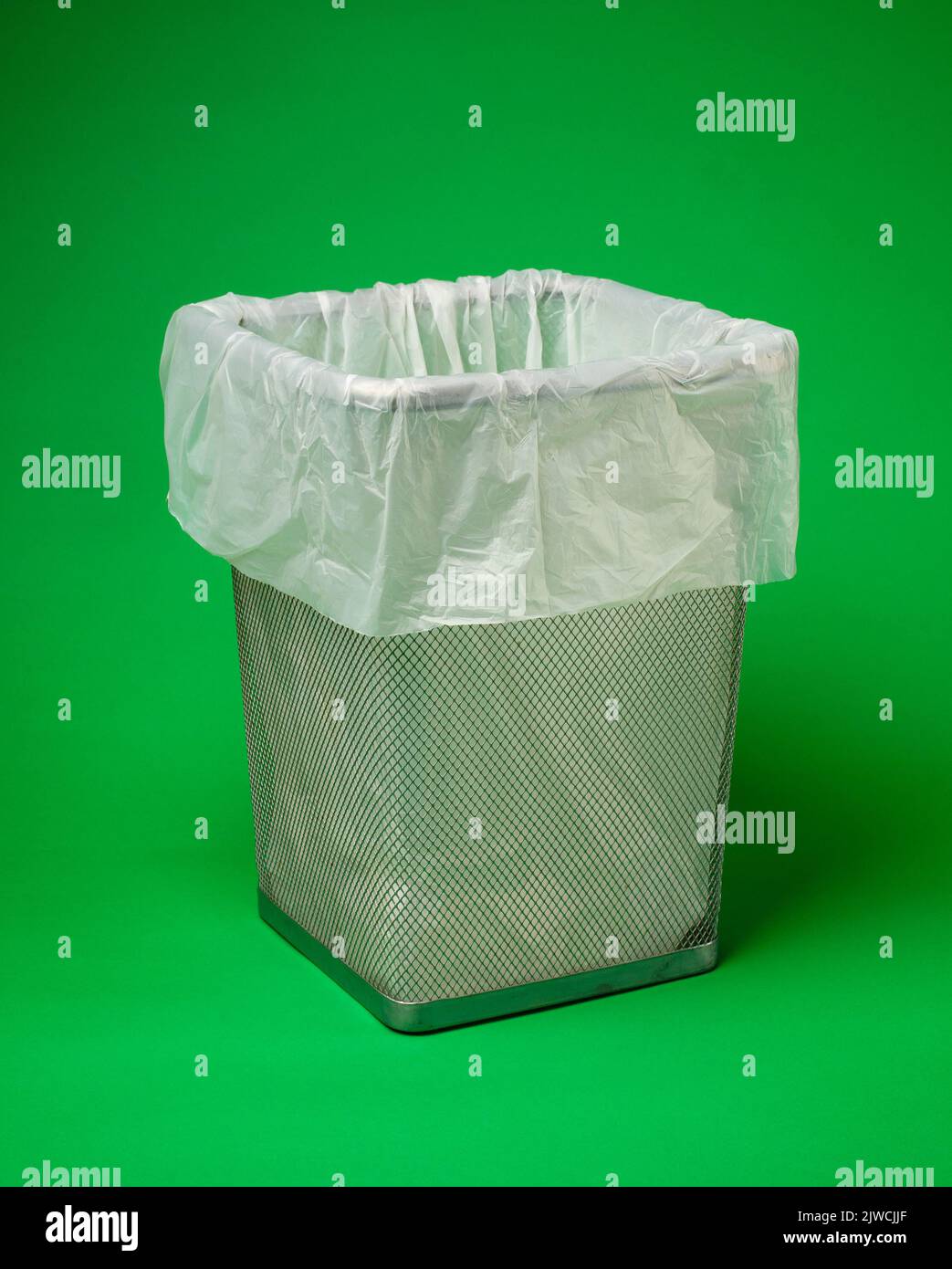 Empty metal trash can with white environmentally friendly biodegradable ...