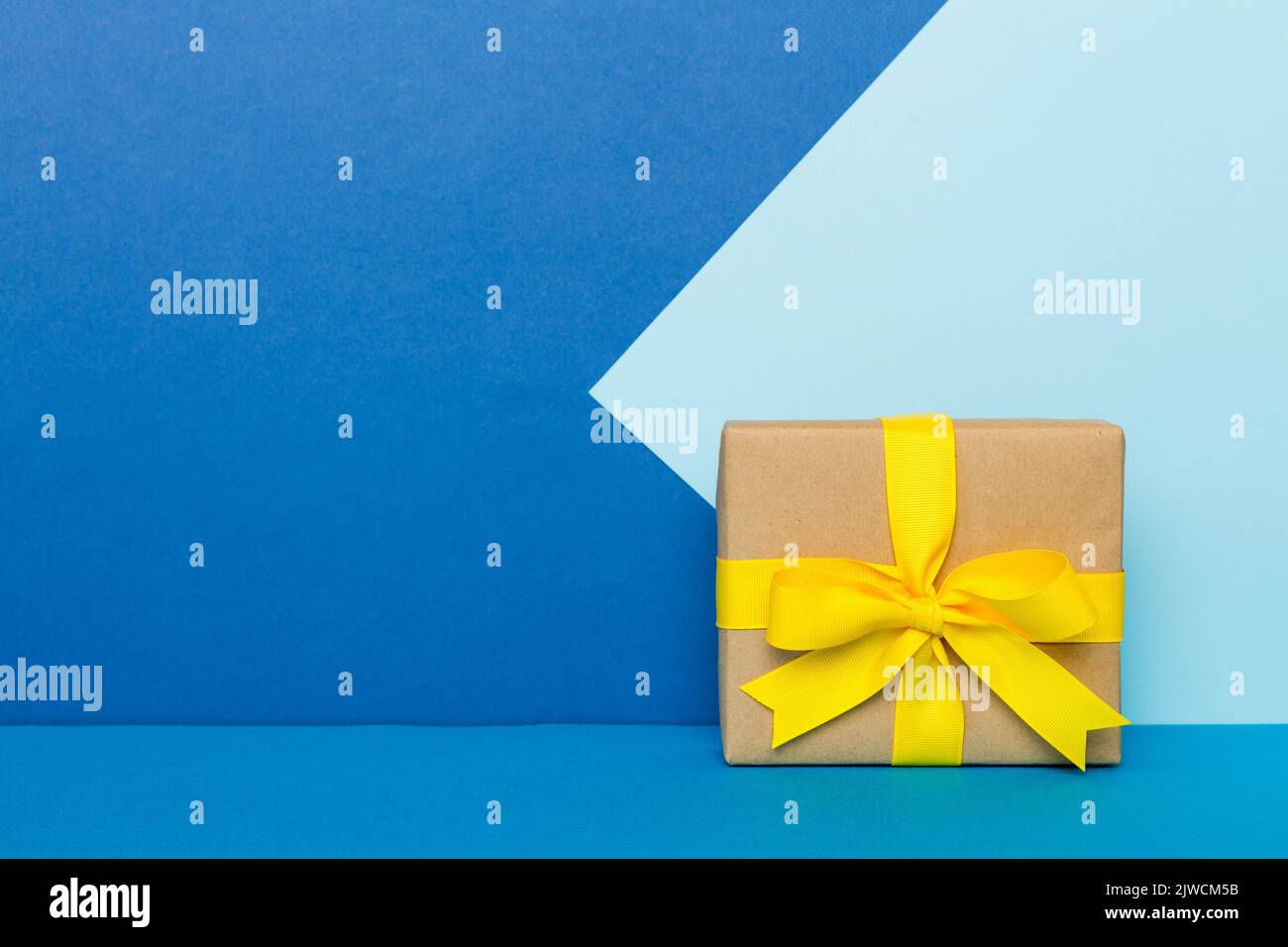 holiday paper present tied yellow ribbon bow top view with copy space ...