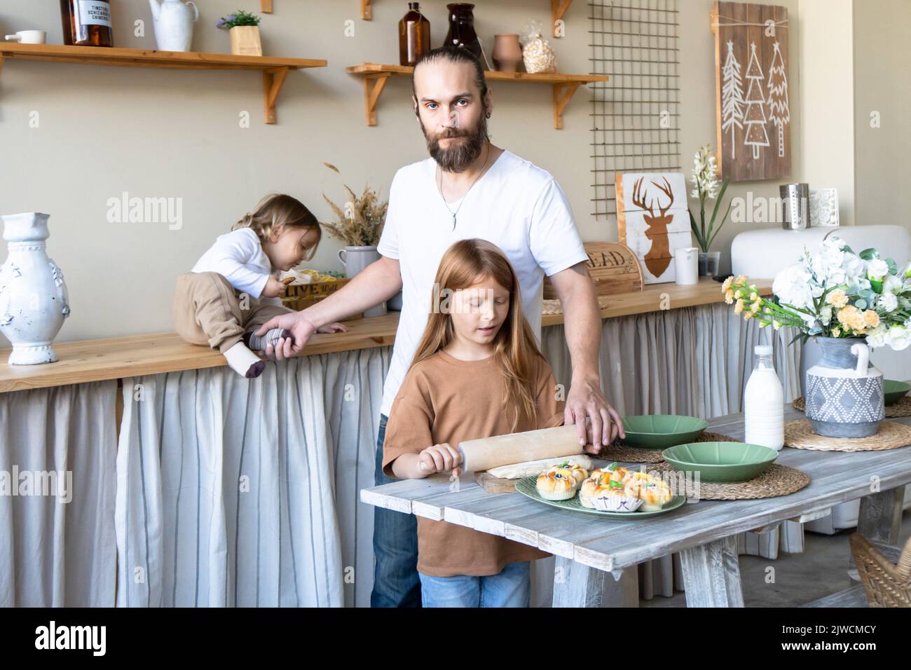 A family with three children has fun baking together.Dad And Daughter ...