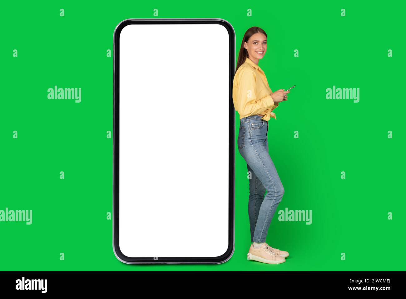 Lady Using Phone Near Big Cellphone Screen Over Green Background Stock ...