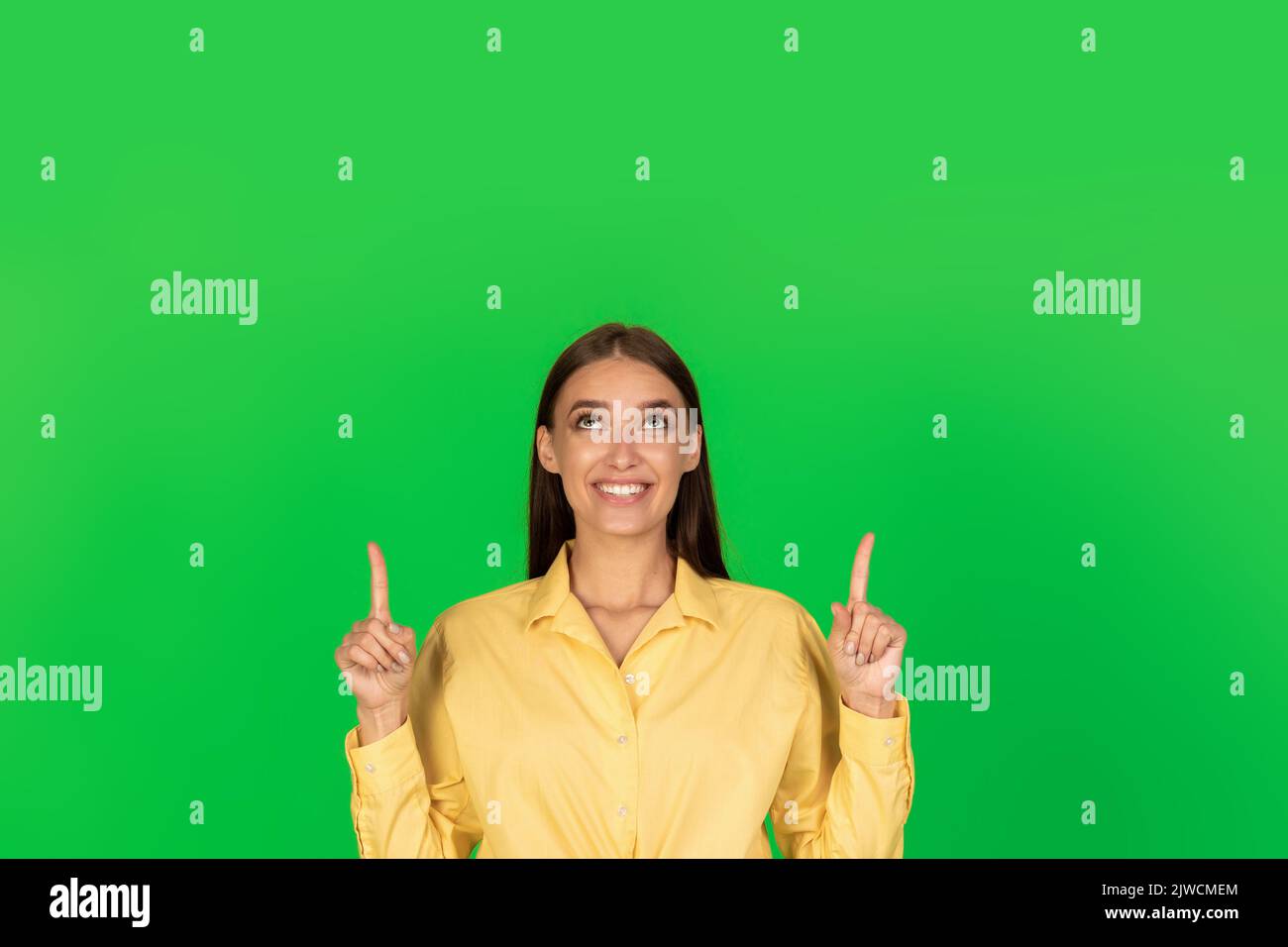 Positive Millennial Lady Pointing Fingers Upward Over Green Background ...