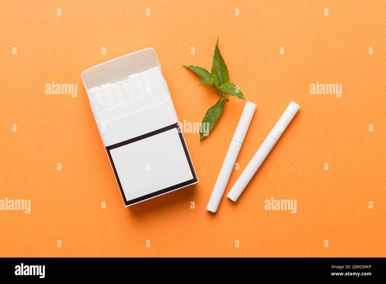 Pack of menthol cigarettes and fresh mint on colored table, Menthol ...