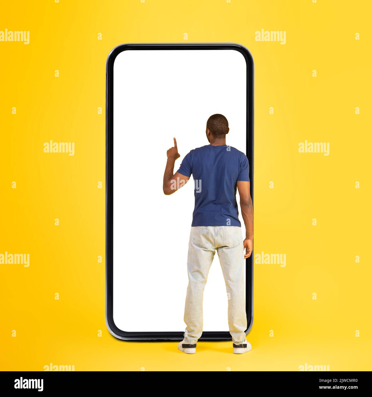 Black Man Using Phone Standing Back To Camera, Yellow Background Stock ...