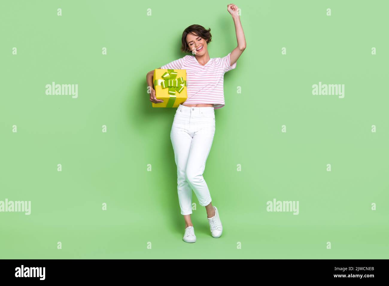 Full length photo of cheerful person fist arms hold giftbox rejoice win ...
