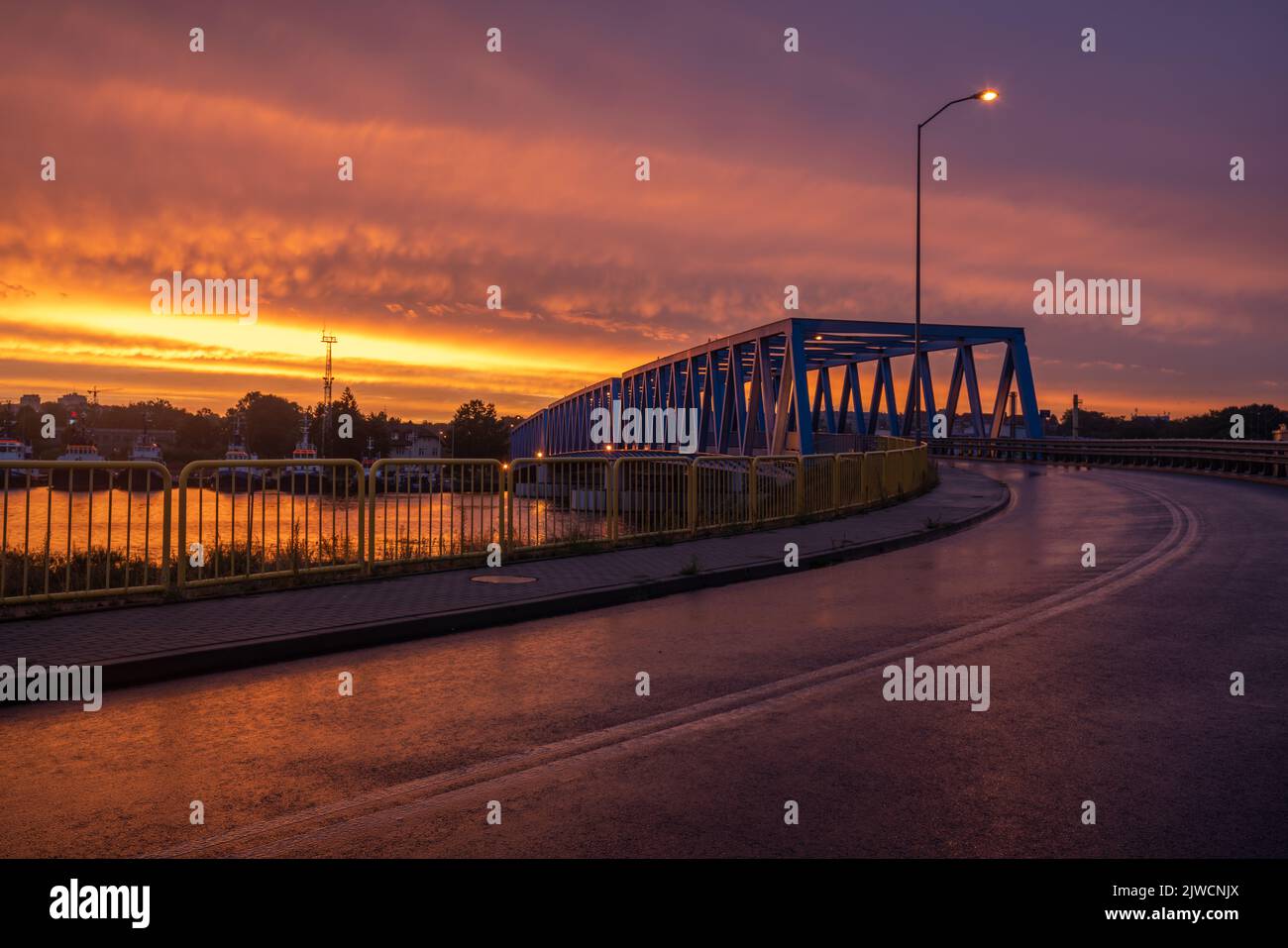 road crossing the truss bridge during an evening thunderstorm Stock ...