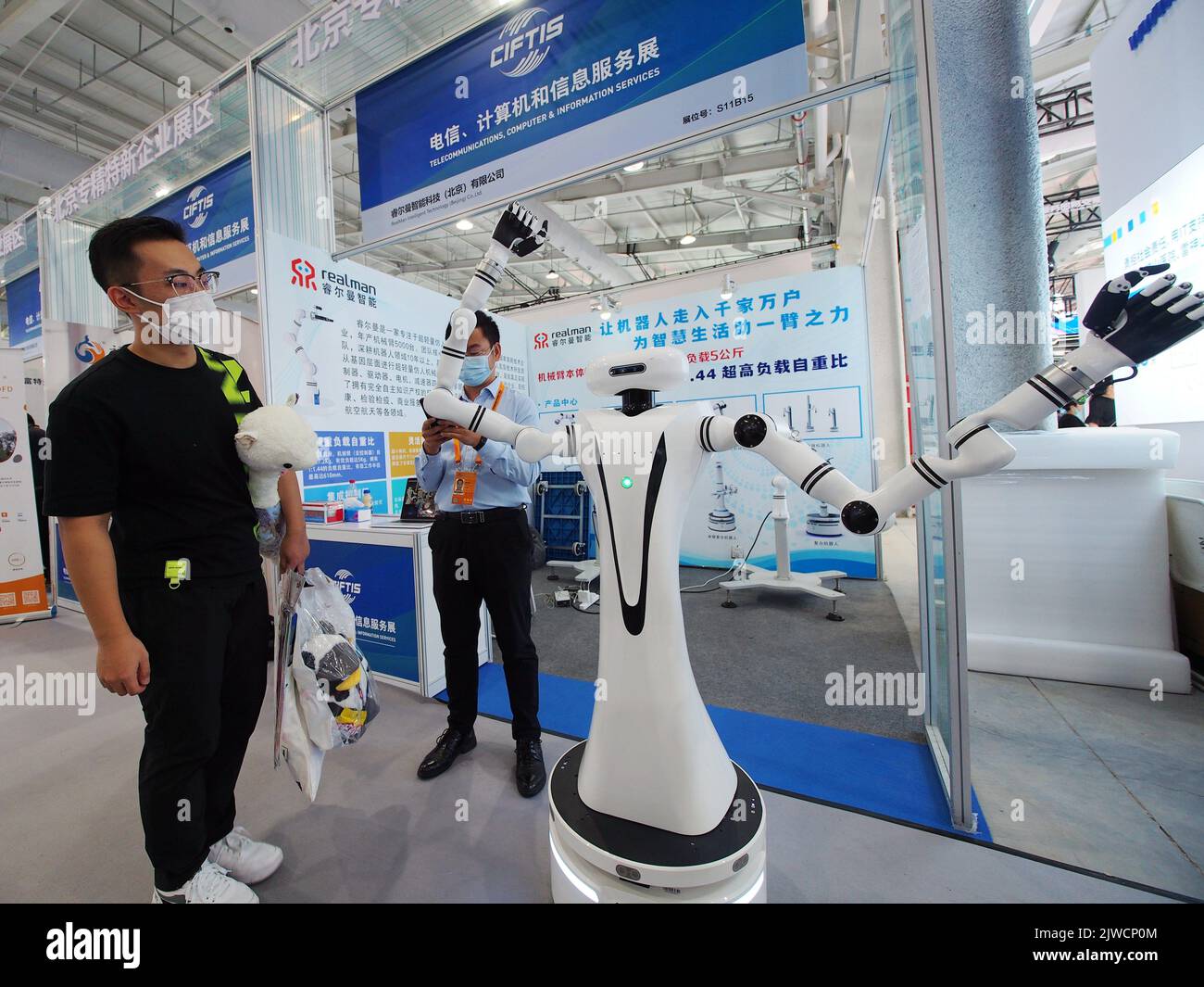 BEIJING, CHINA - SEPTEMBER 5, 2022 - A visitor looks at a two-arm ...