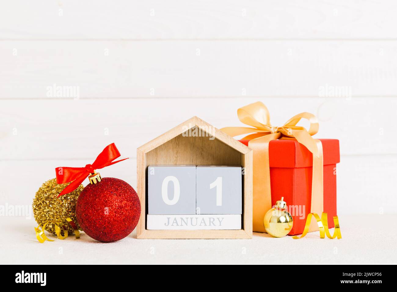 1 january. Christmas composition on colored background with a wooden ...