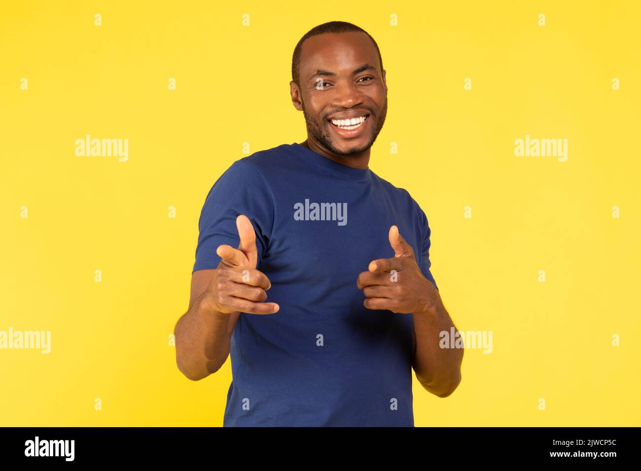 Cheerful African Male Pointing Fingers At Camera Over Yellow Background ...