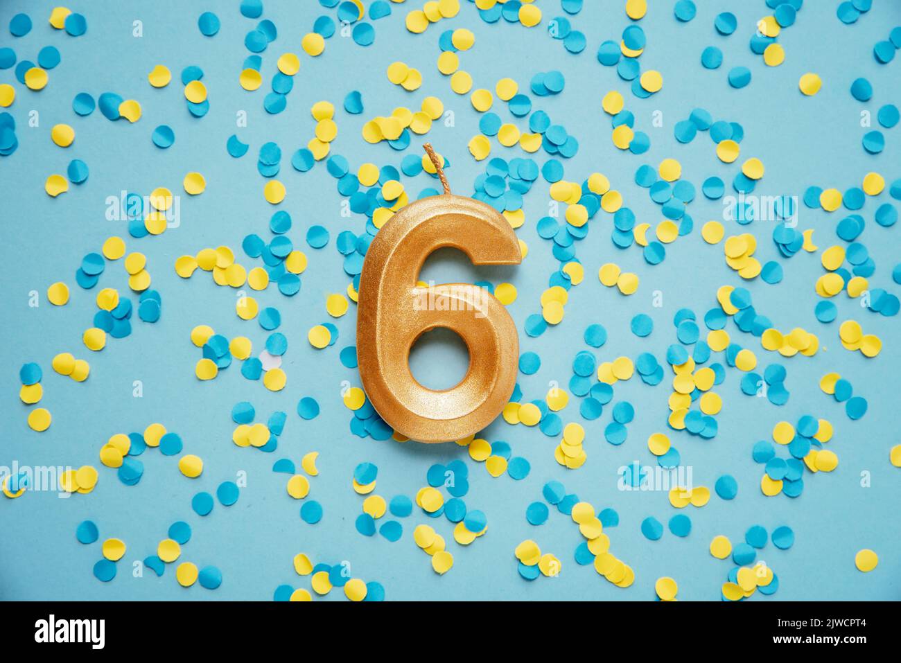 Number 6 six golden celebration birthday candle on yellow and blue ...