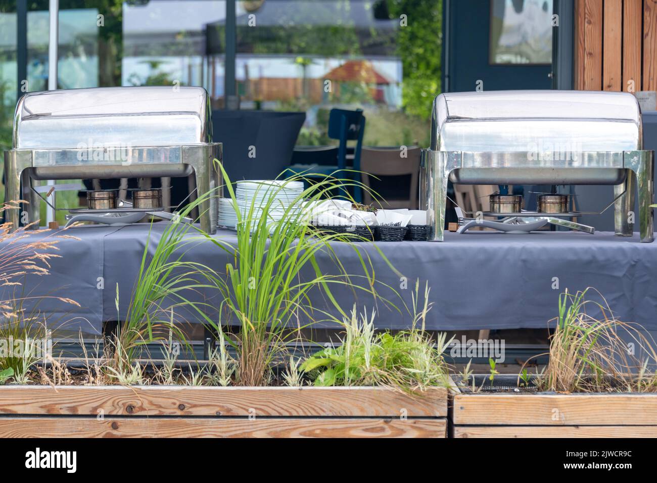 Buffet heated trays standing in line ready for service. Outdoors buffet ...