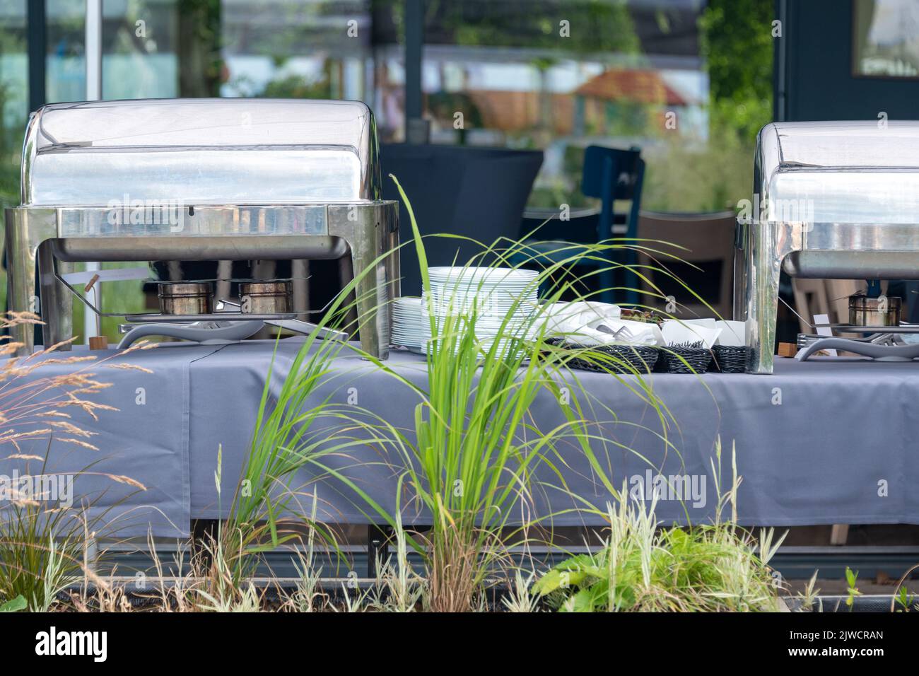 Buffet heated trays standing in line ready for service. Outdoors buffet ...