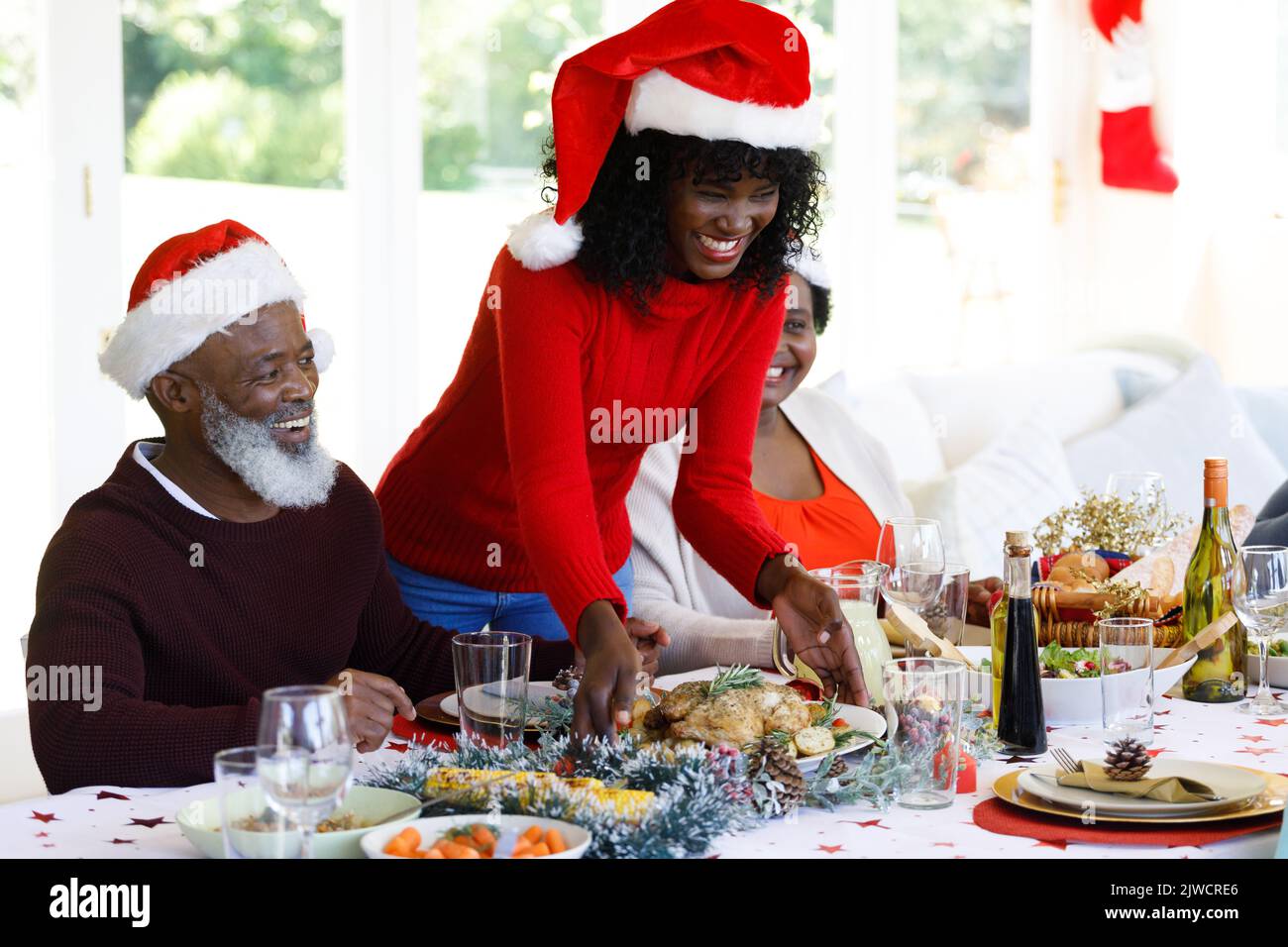 African american woman serving dinner Stock Photo - Alamy