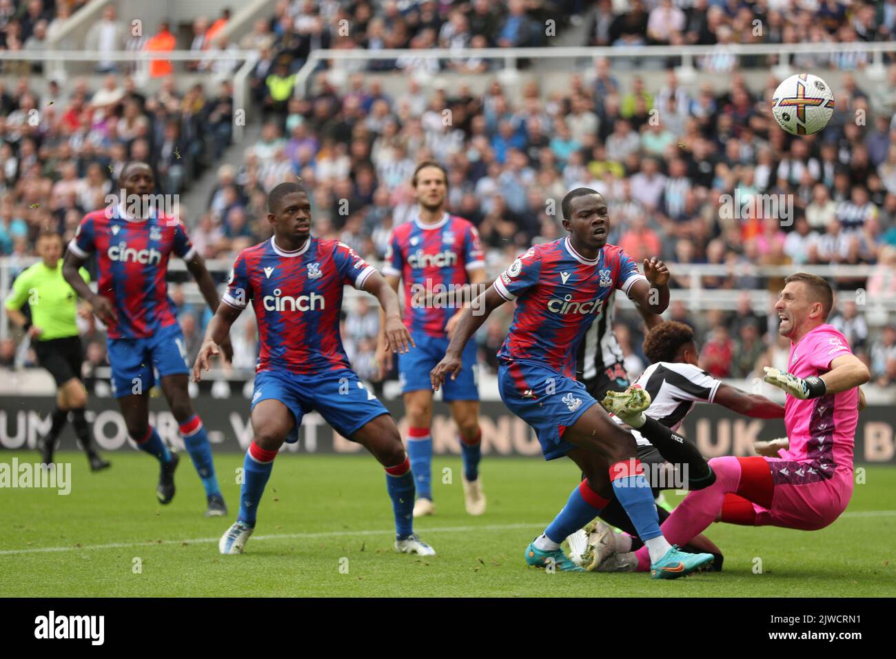 Vicente Guaita of Crystal Palace is fouled by Joe Willock of Newcastle United as Tyrick Mitchell ...