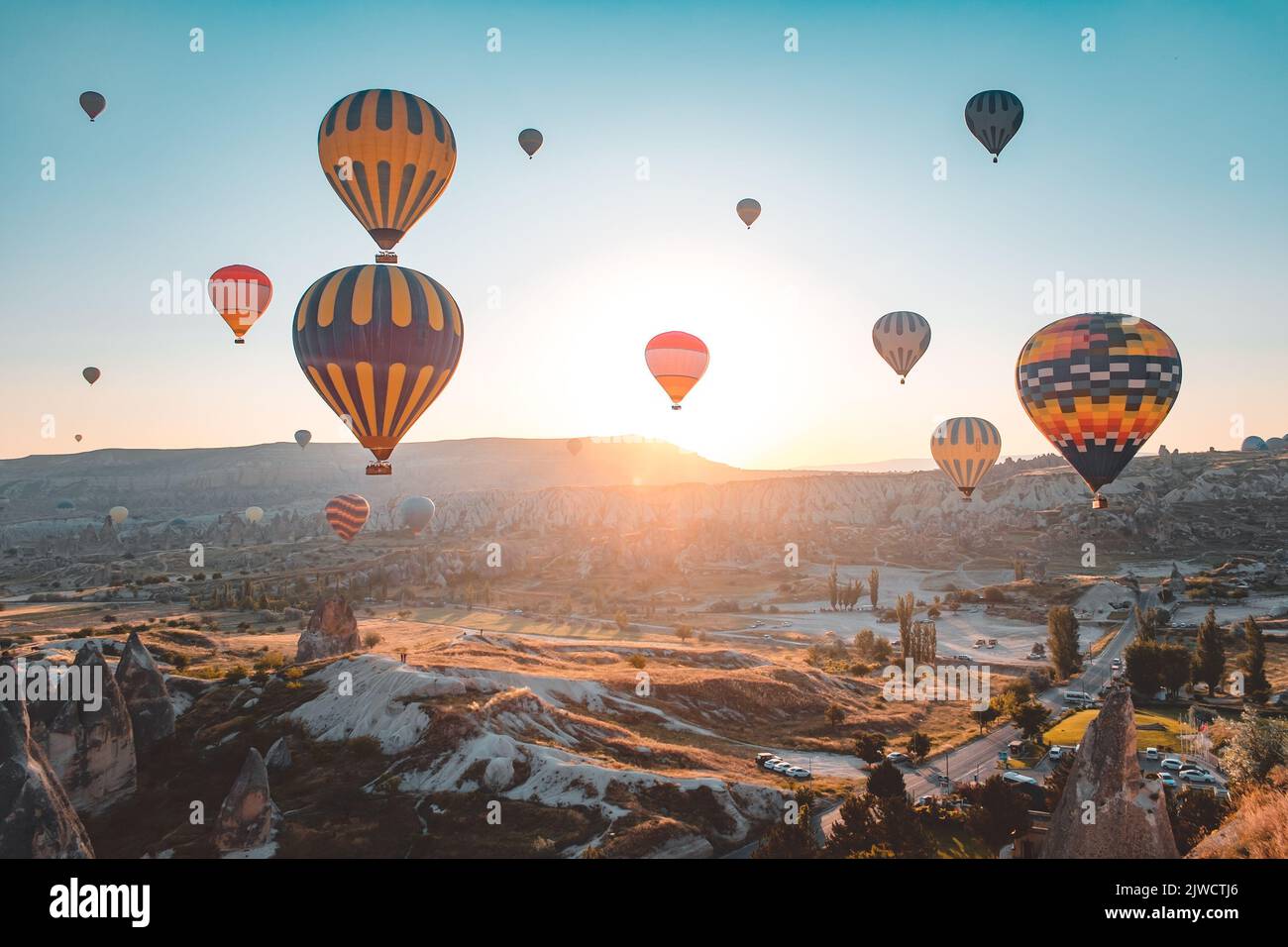 Cappadocia sunrise hot air balloons fly over Goreme valley landscape ...
