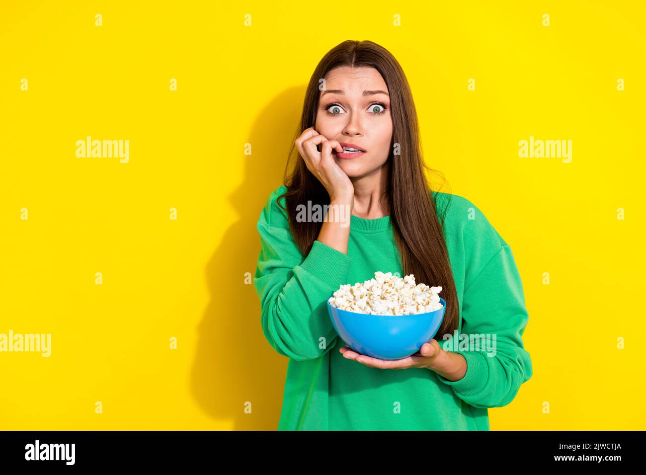 Photo of crazy frightened person arm hold popcorn biting finger nails ...