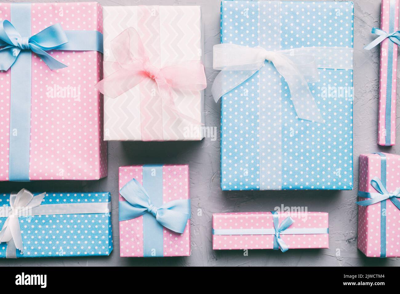 A lot of Christmas gift boxes in colored paper decorated on table, Top ...