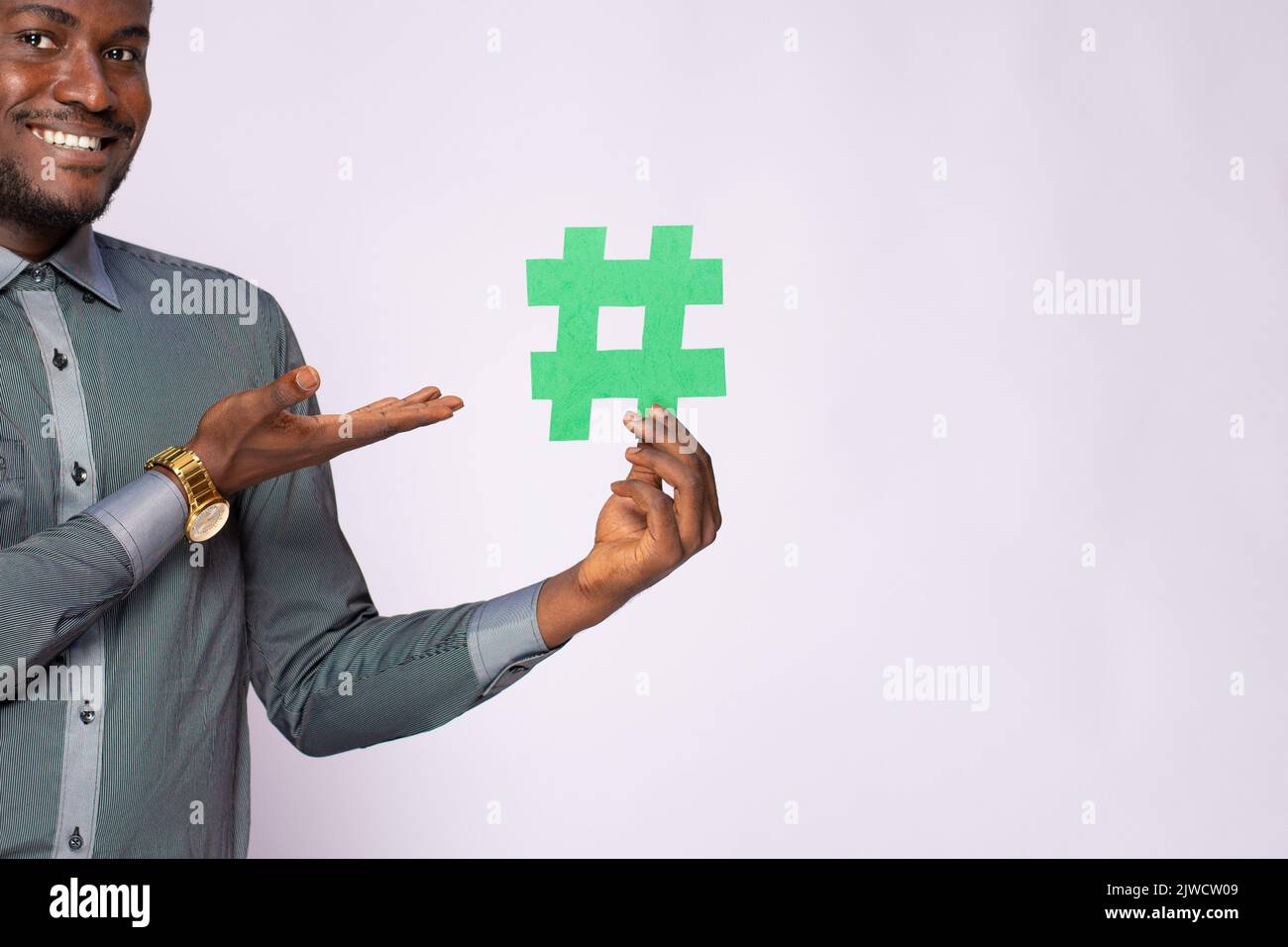 african businessman holding a hash tag symbol Stock Photo - Alamy